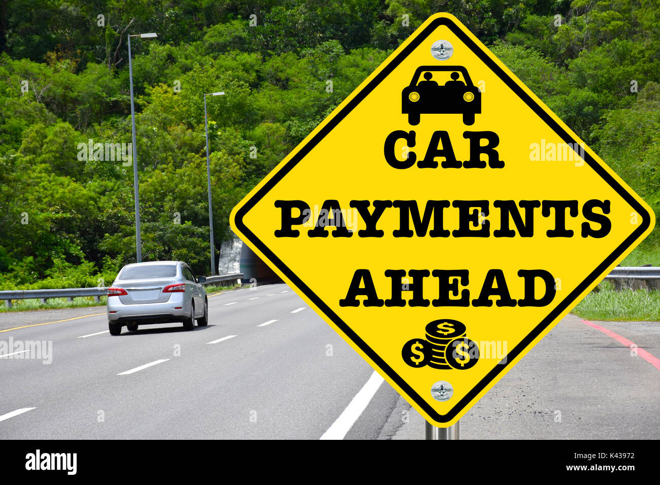 Car payments ahead road yellow warning sign Stock Photo - Alamy