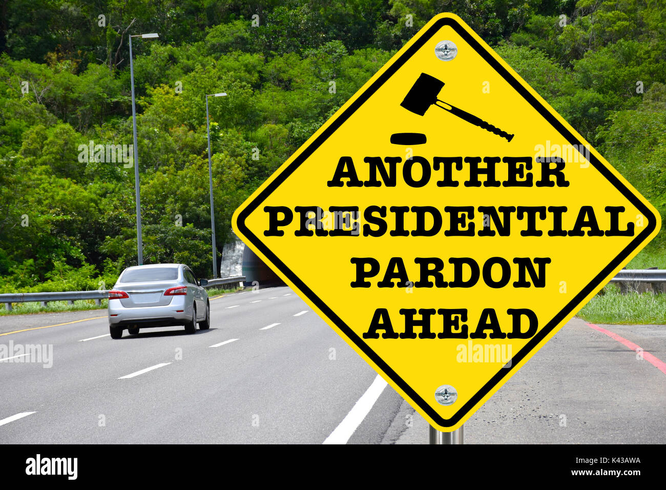 Another presidential pardon ahead, yellow road sign Stock Photo - Alamy