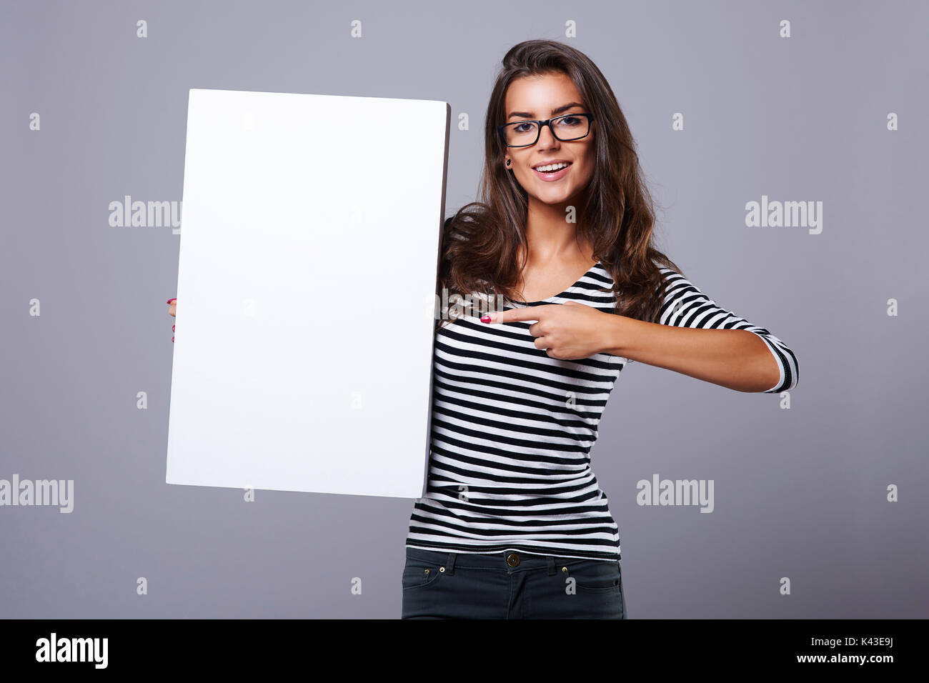 Rectangular white placard held by attractive brunette Stock Photo - Alamy