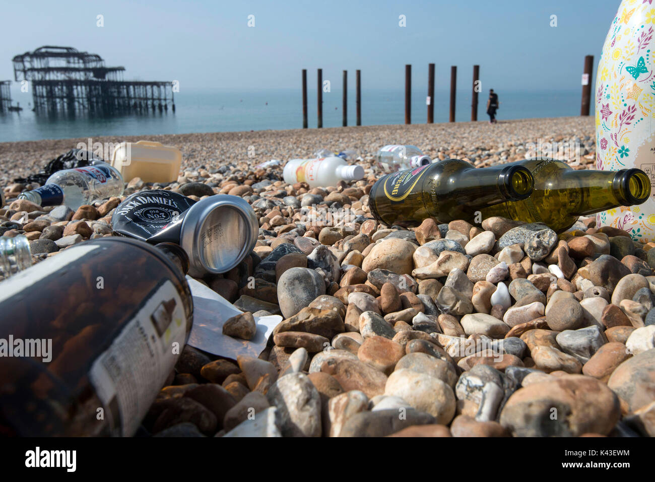Empty alcohol bottles and cans are discarded on a beach in Brighton ...