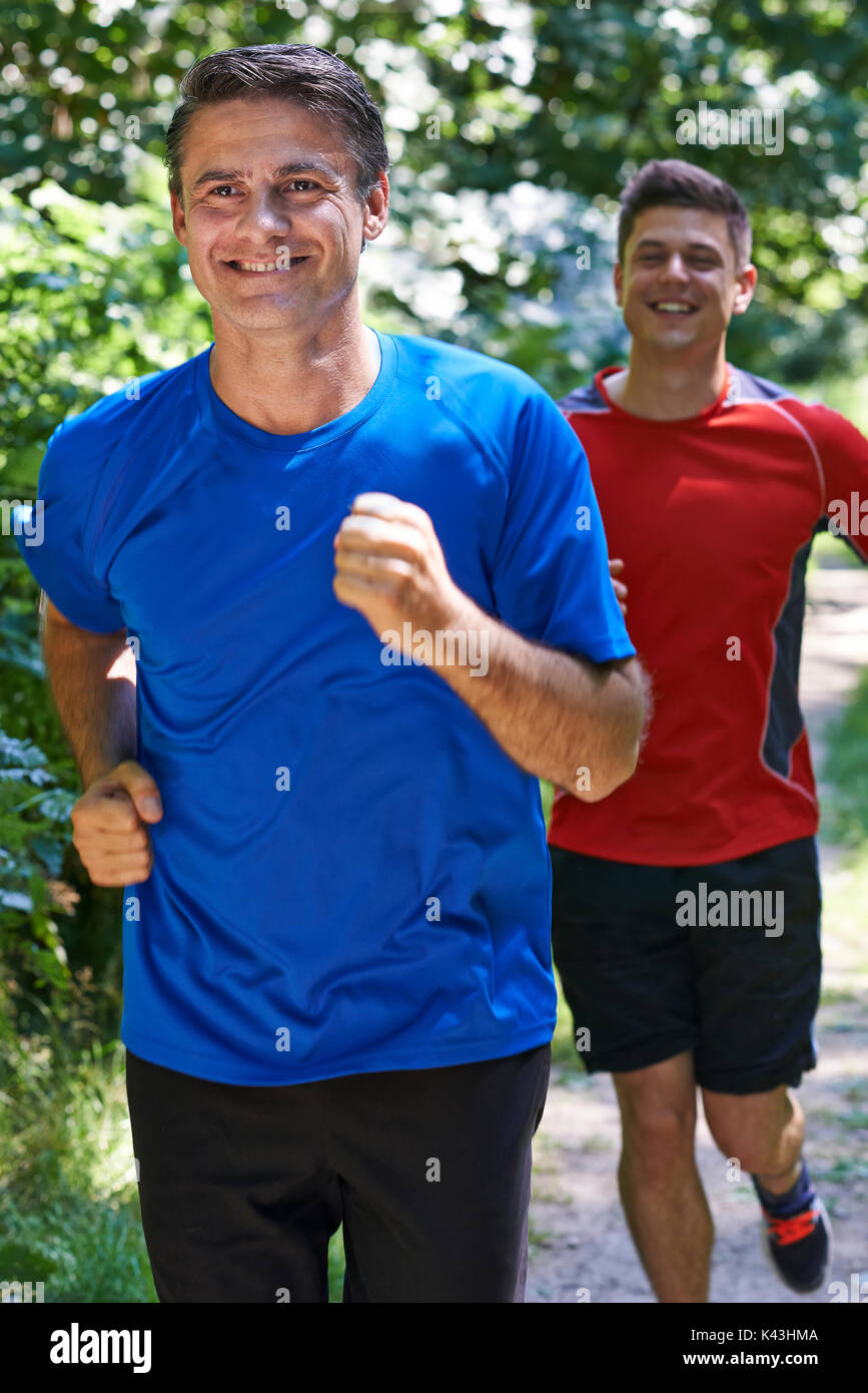 Two Men Running In Countryside Together Stock Photo - Alamy