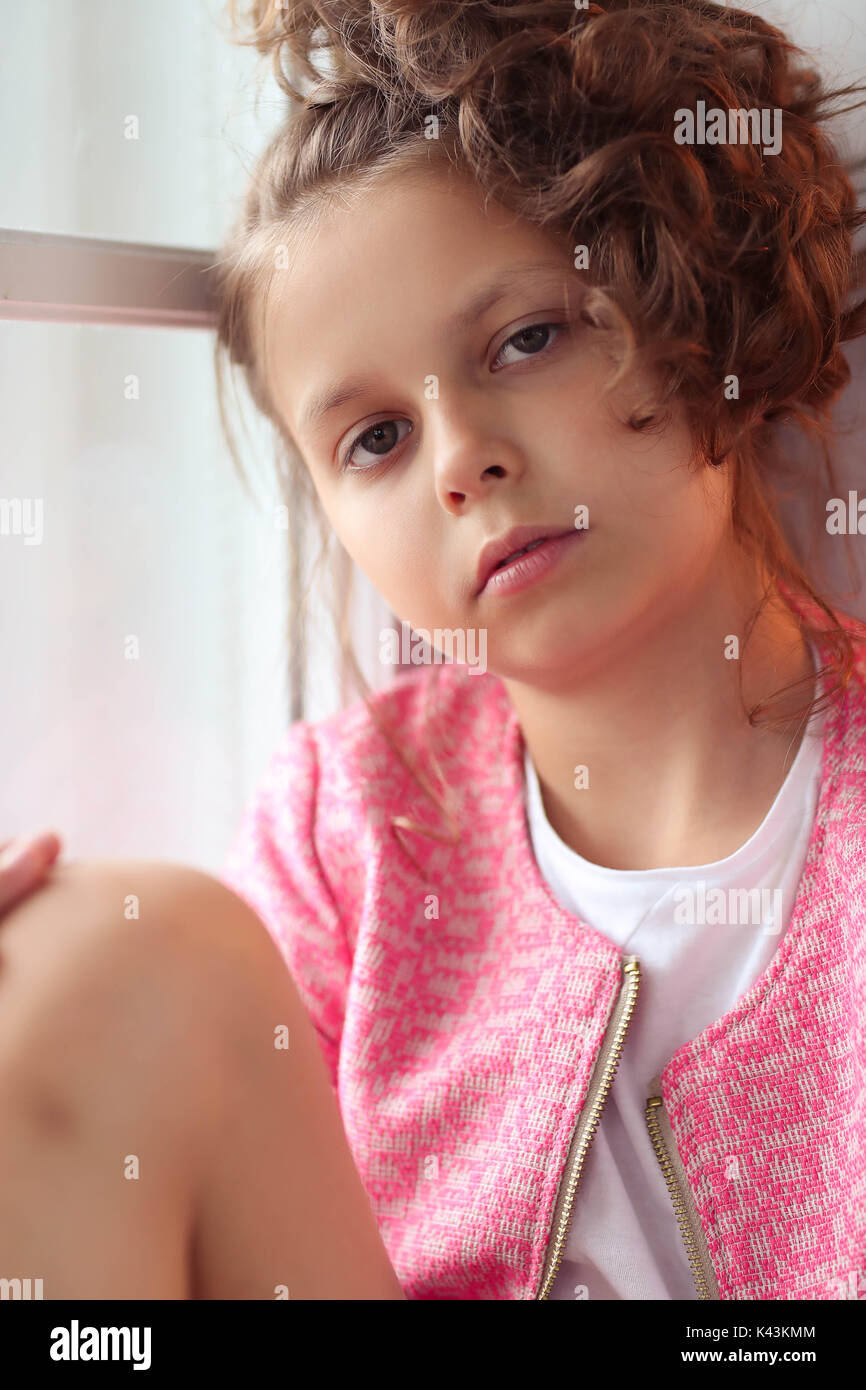 Young girl is posing by the window Stock Photo - Alamy