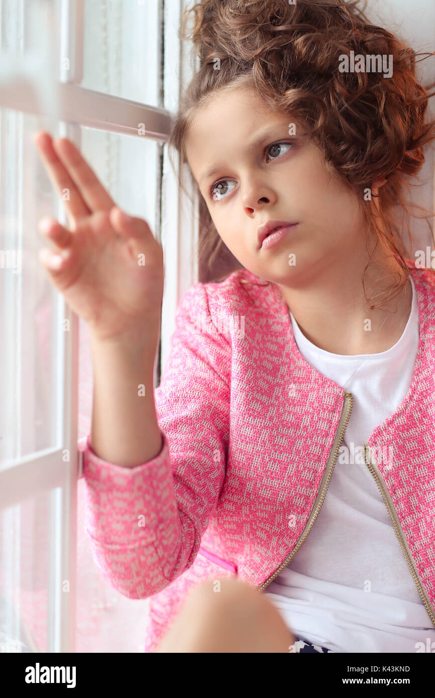 Young girl is posing by the window Stock Photo - Alamy