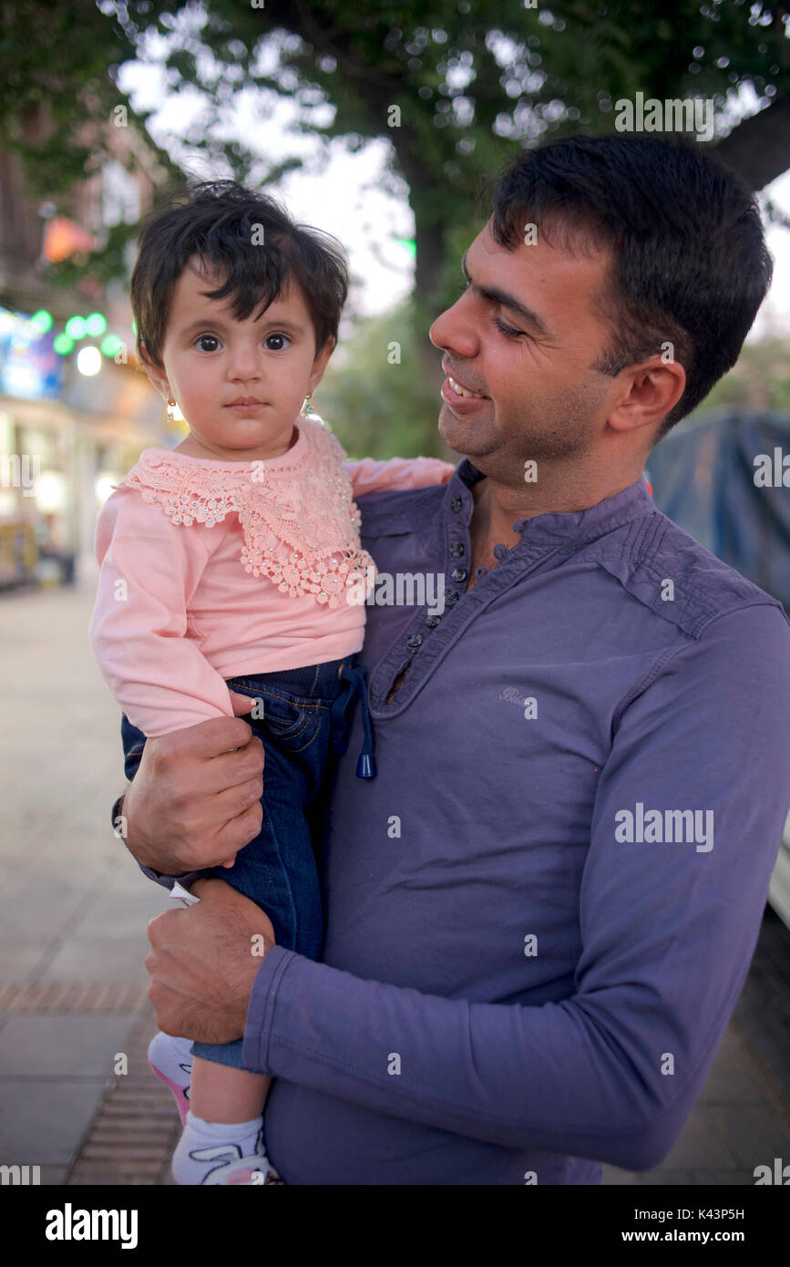 Iranian father holding young girl, Shiraz, Iran Stock Photo - Alamy