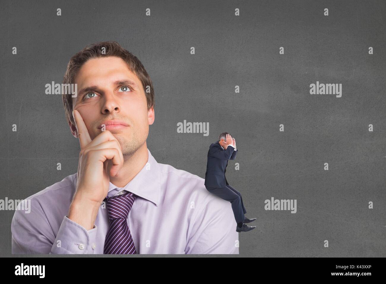 Digital composite of Small business man sitting on a big business man ...