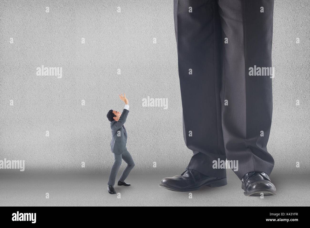 Digital composite of Scared small business man looking at a big ...