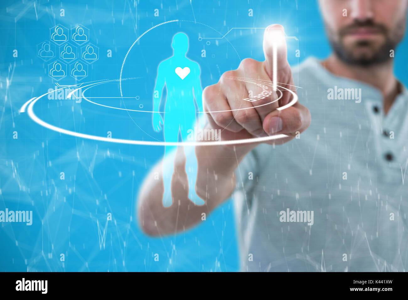 Man touching invisible object against blue background Stock Photo - Alamy