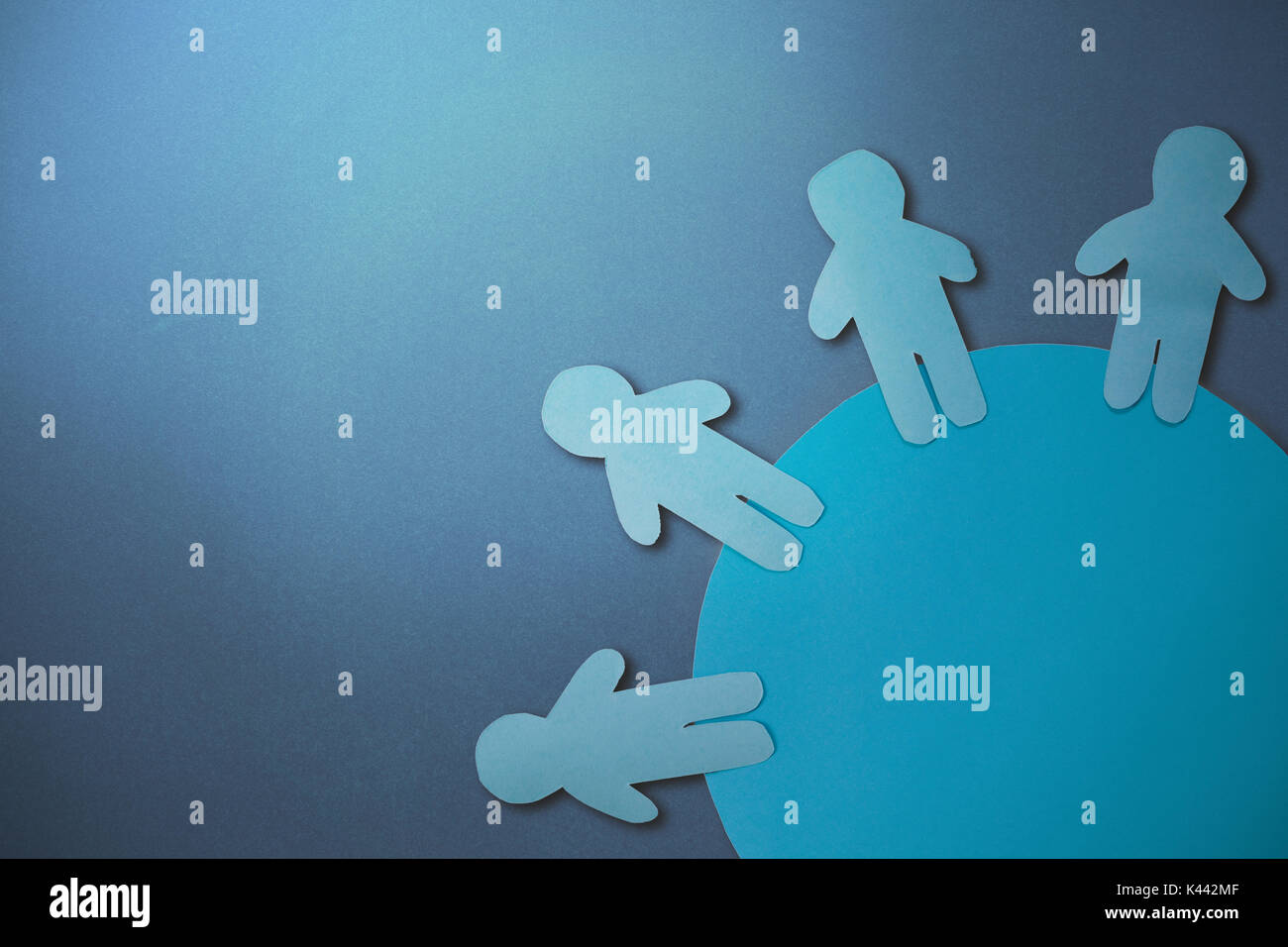 Little blue person standing against blue background Stock Photo - Alamy