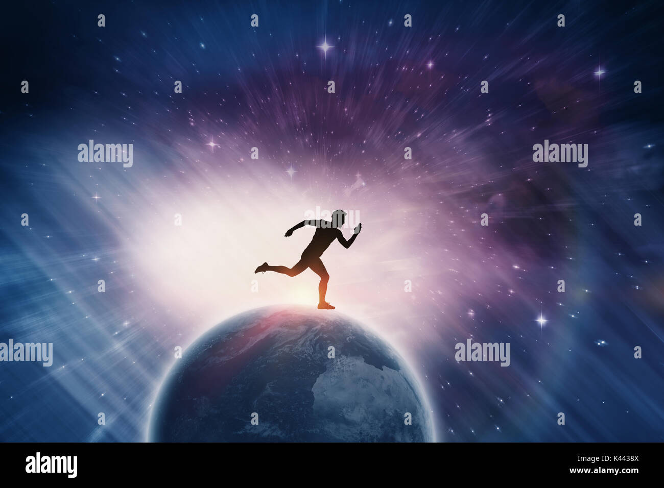 Confident male athlete running from starting blocks against outer space ...