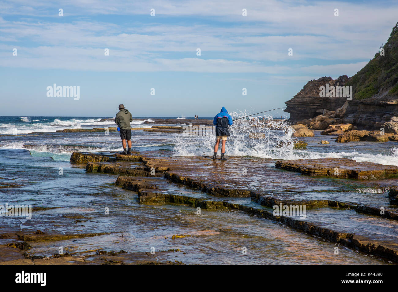 Two australian men rock fishing off the coast at Turimetta beach Sydney ...