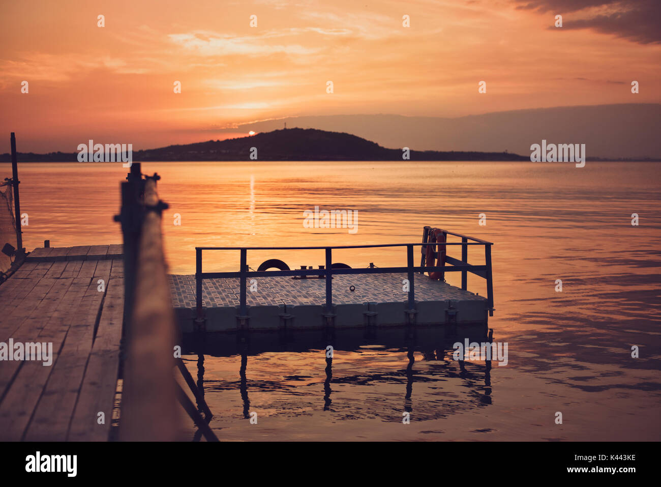 Wooden bridge on the beach and beautiful sunset near the sea. Filter ...