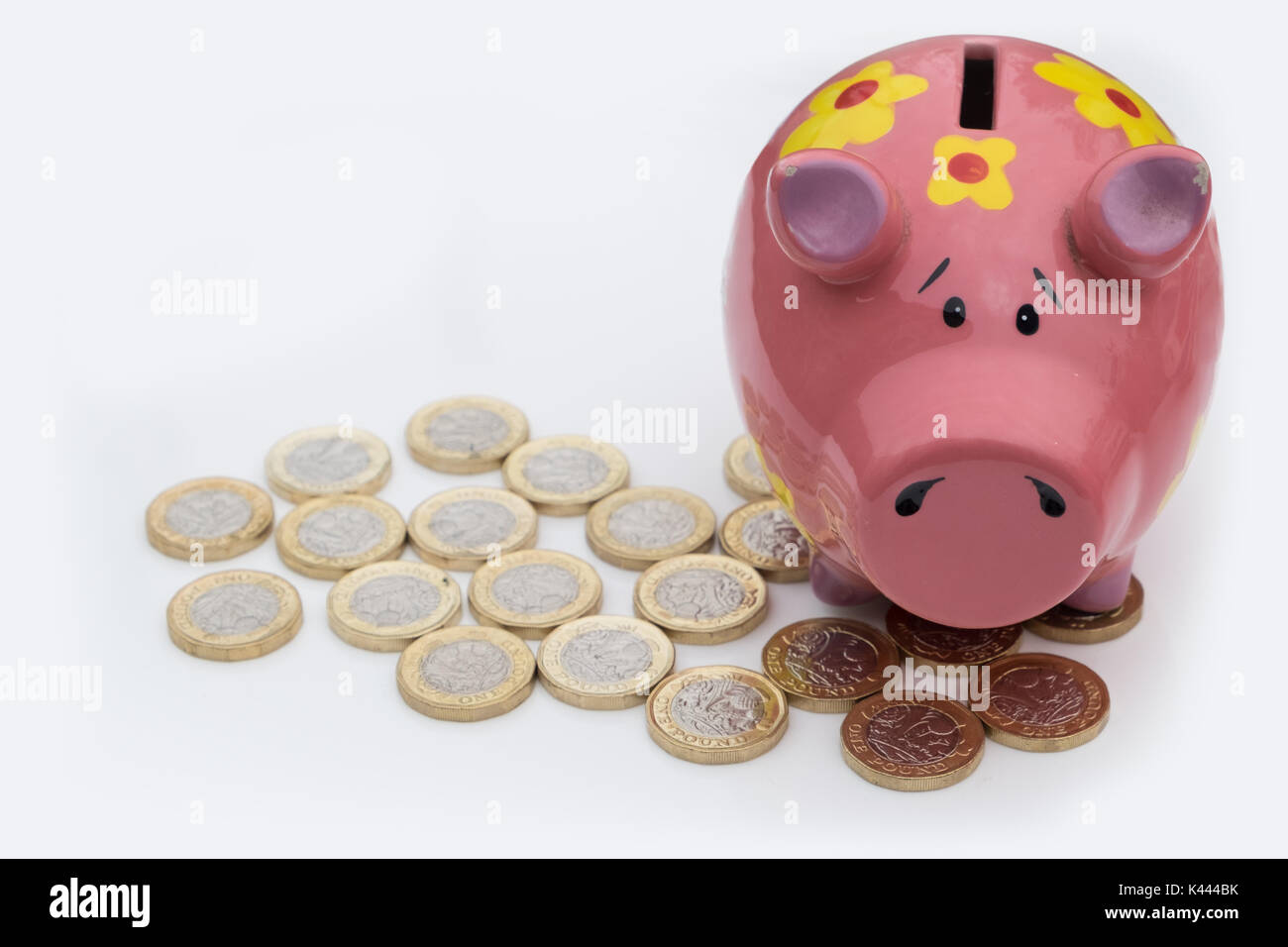 Piggy bank style money box with UK sterling money coins Stock Photo - Alamy
