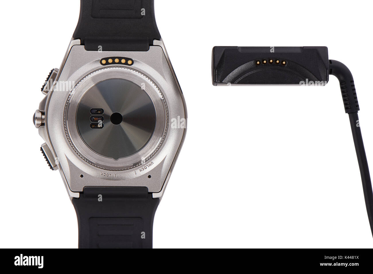 closeup of charge terminal on the back of smart watch and cable. Smart ...