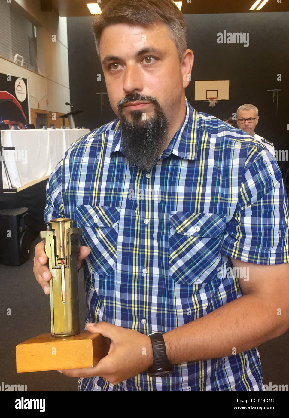 Bomb disposal expert Rene Bennert shows a model of the three detonators ...