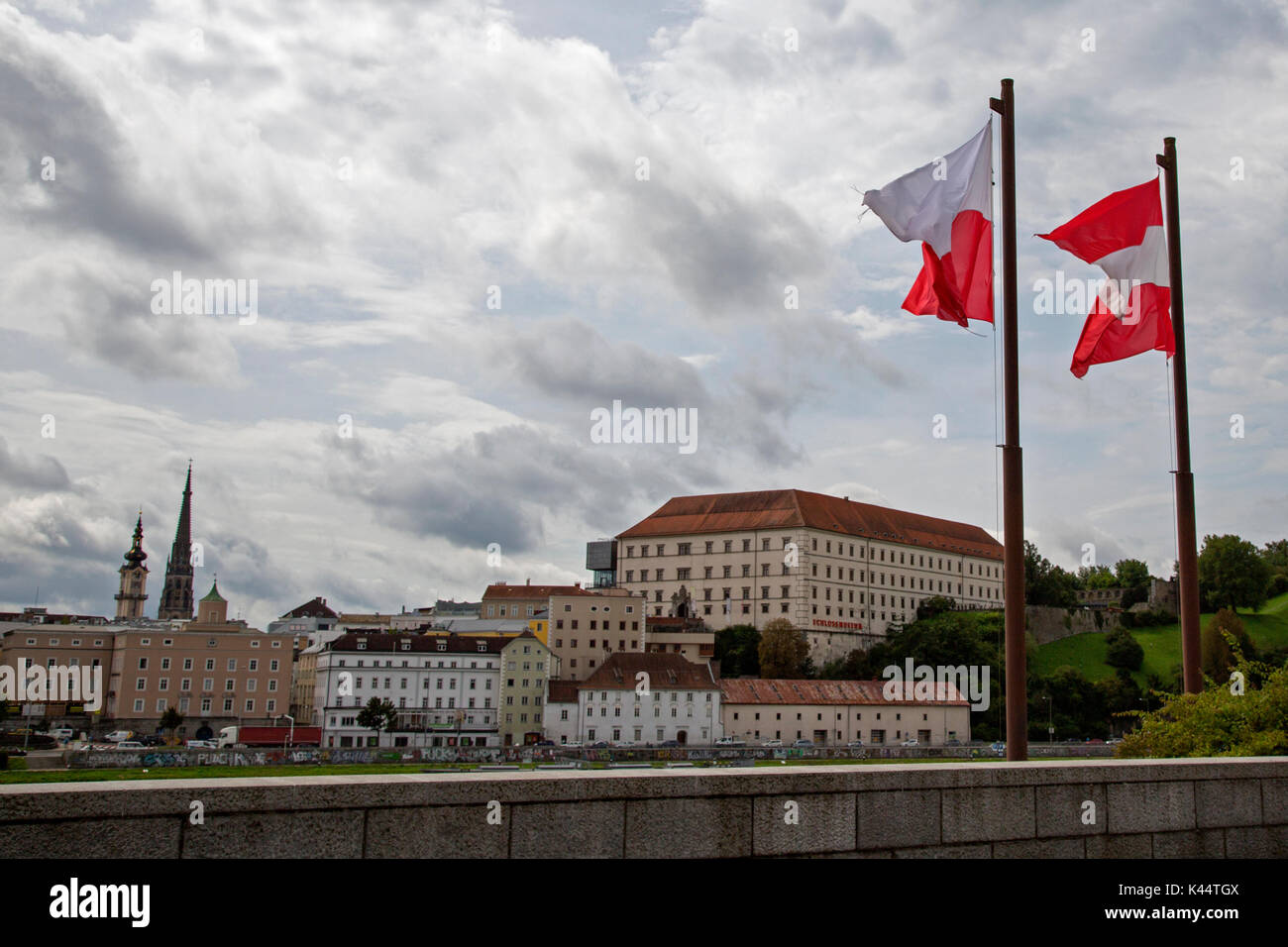 The Austrian and regional flags fly side by side on the banks of the ...