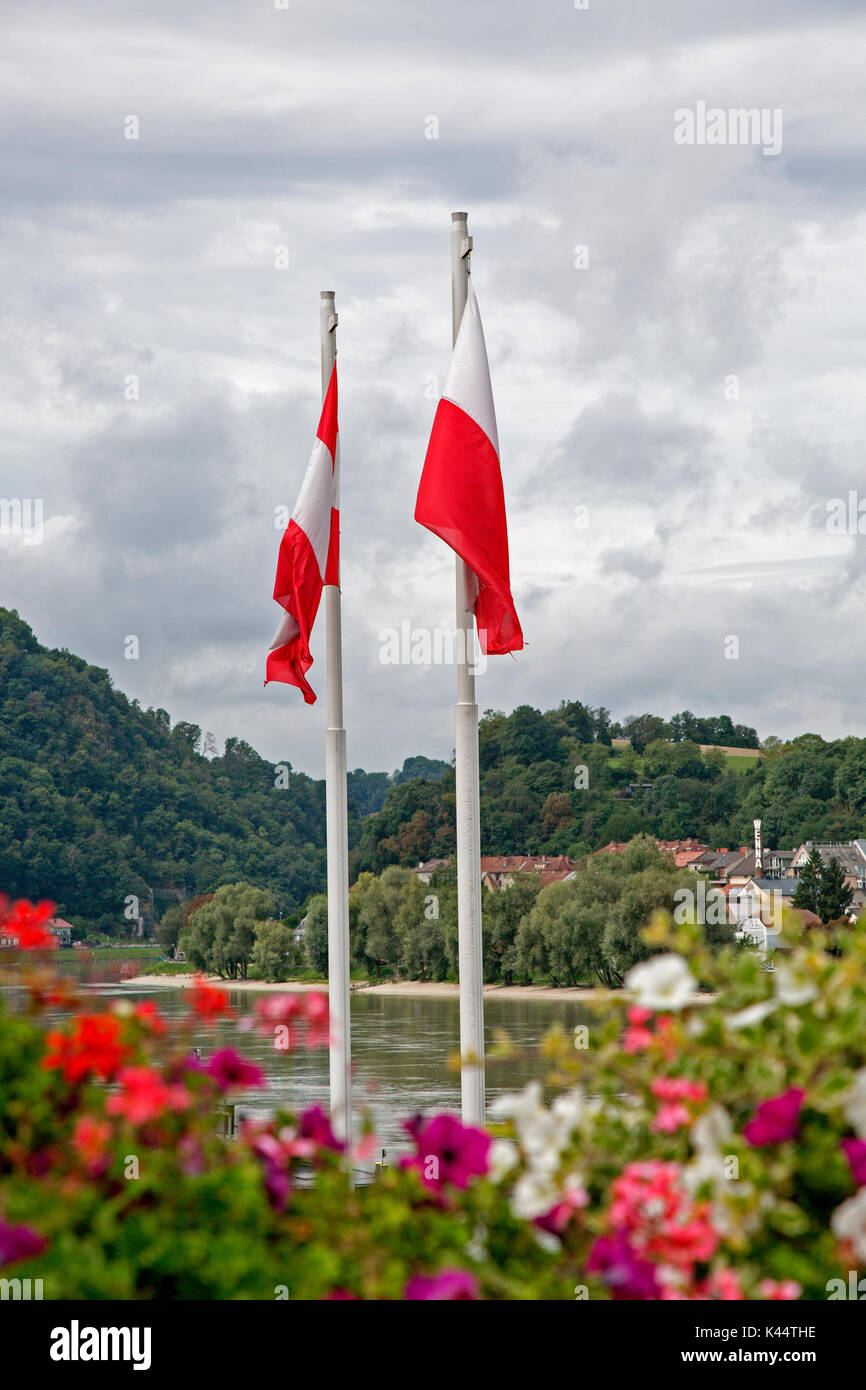 The Austrian and regional flags fly side by side on the banks of the ...