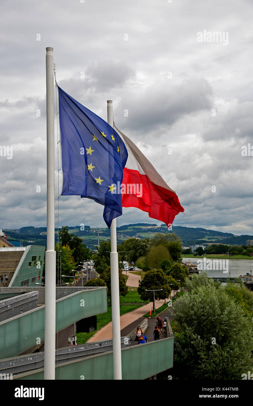 The Austrian and EU flags fly outside the Electronica Centre in Linz ...