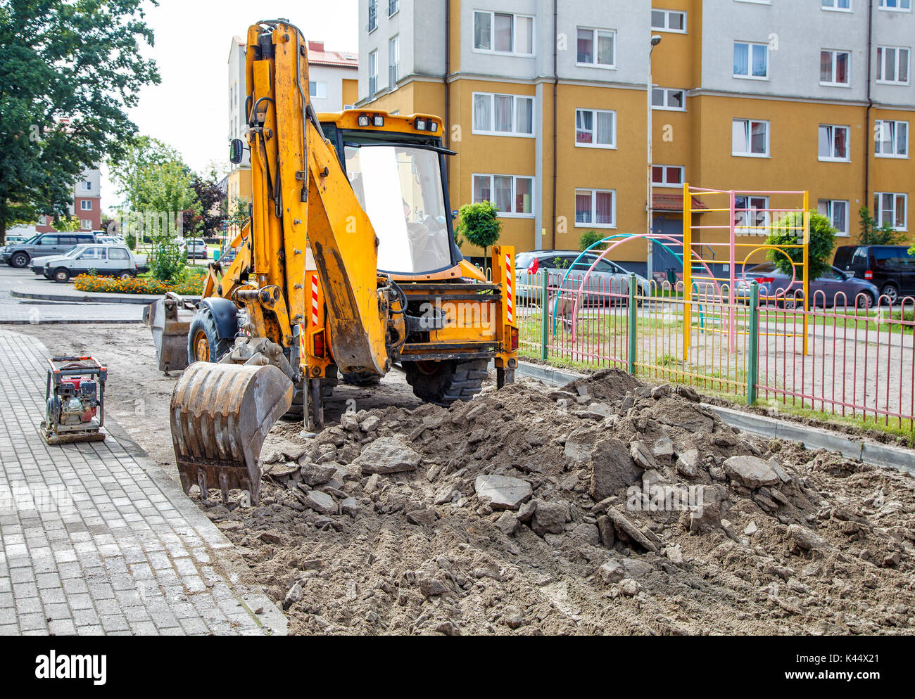 construction of a new road. excavator prepares the surface in the city ...