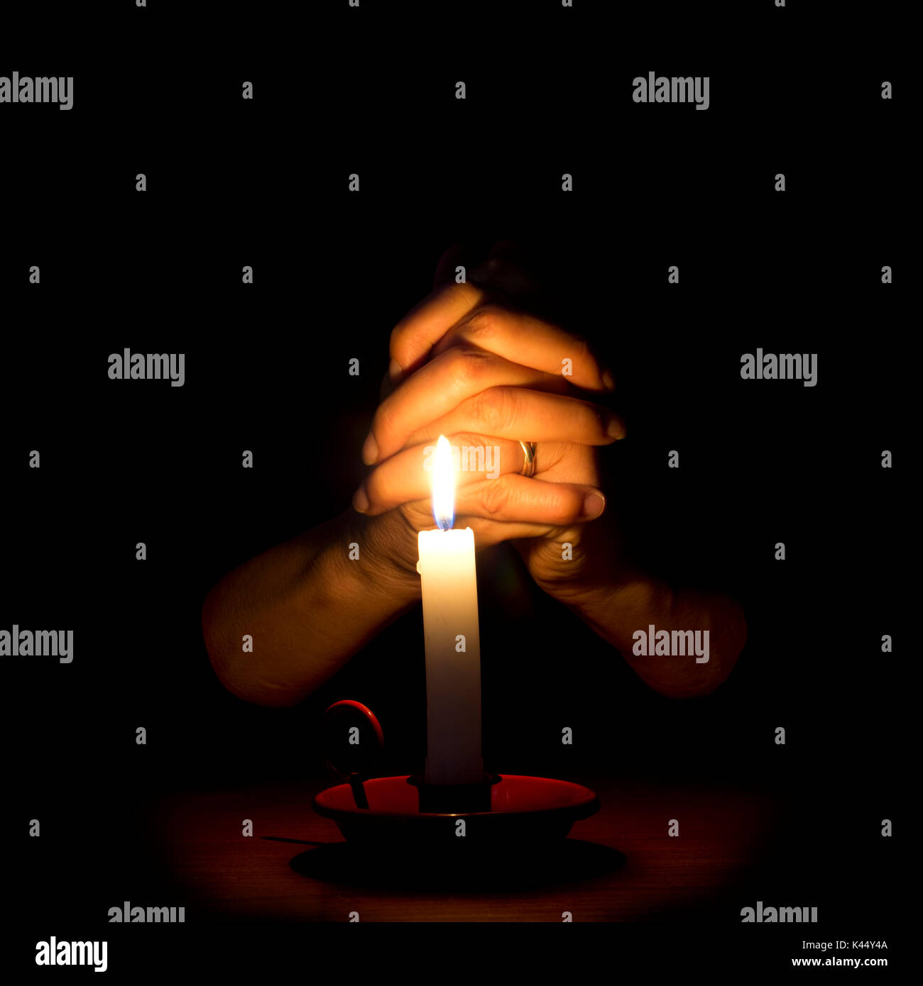 Religious image. Closeup of hands, retro candlestick Stock Photo - Alamy