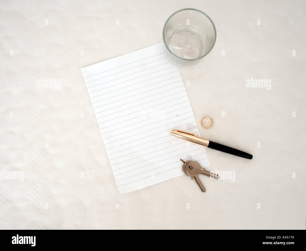 Leaving you. Objects include pen, keys and wedding ring on tear stained ...