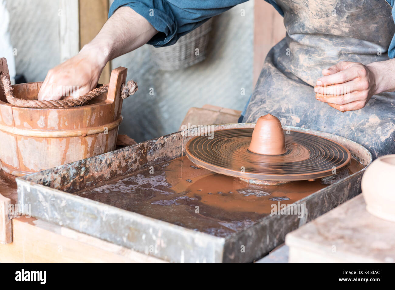 Man making pot on potter wheel in a workshop Stock Photo - Alamy