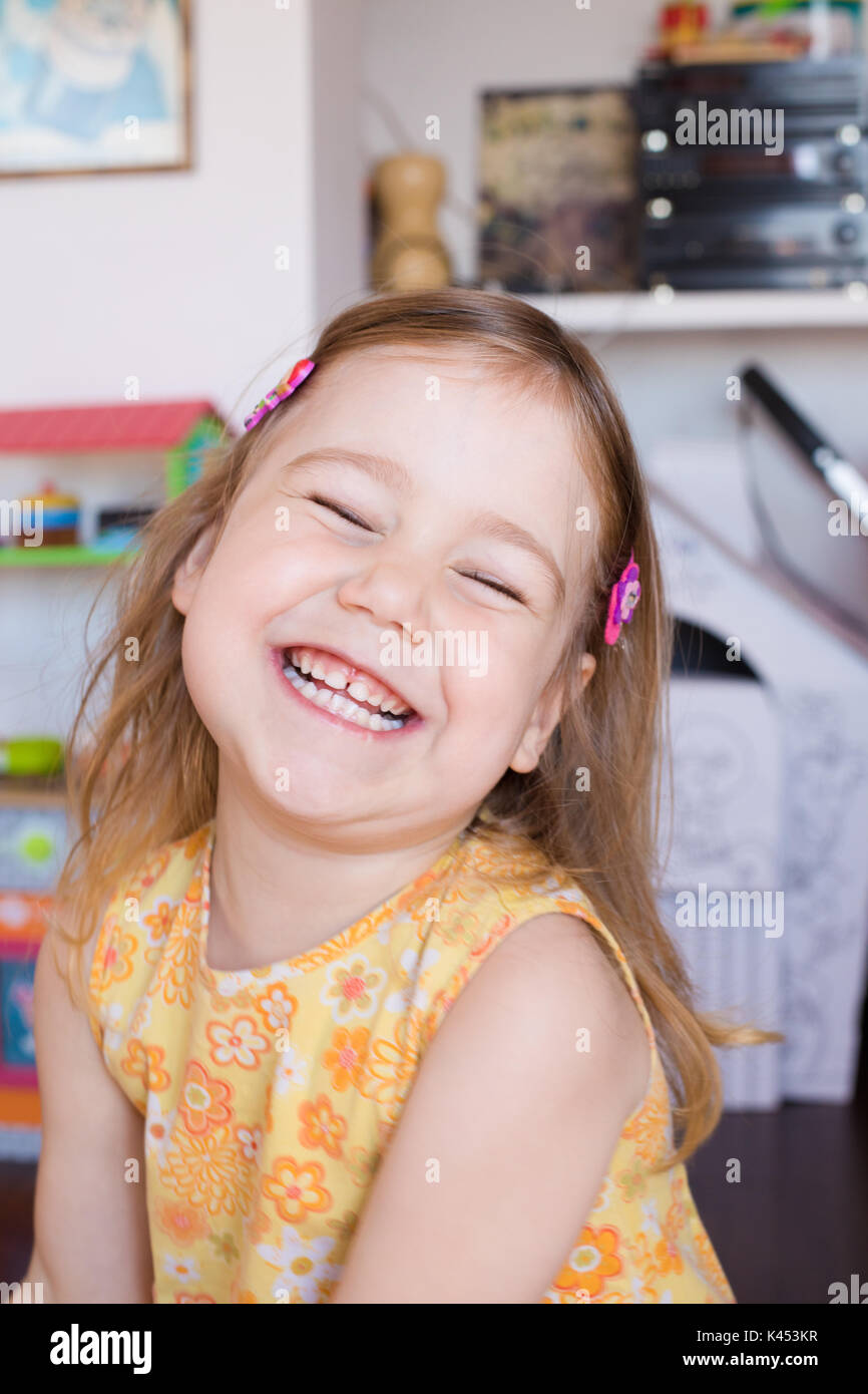 portrait of three years old blonde pretty girl face, with yellow dress ...