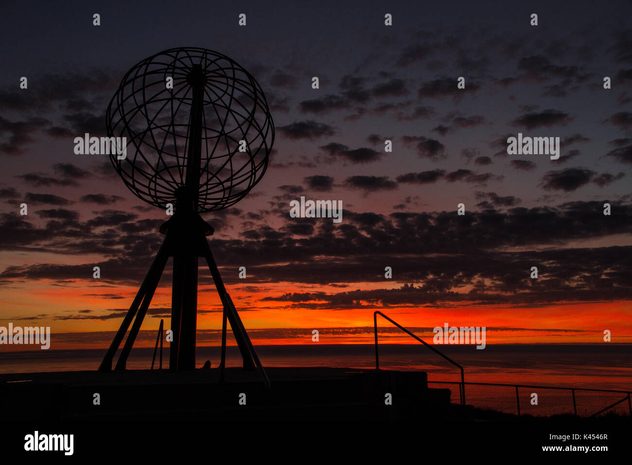 Sunset over the globe statue at the North Cape, the northernmost point ...
