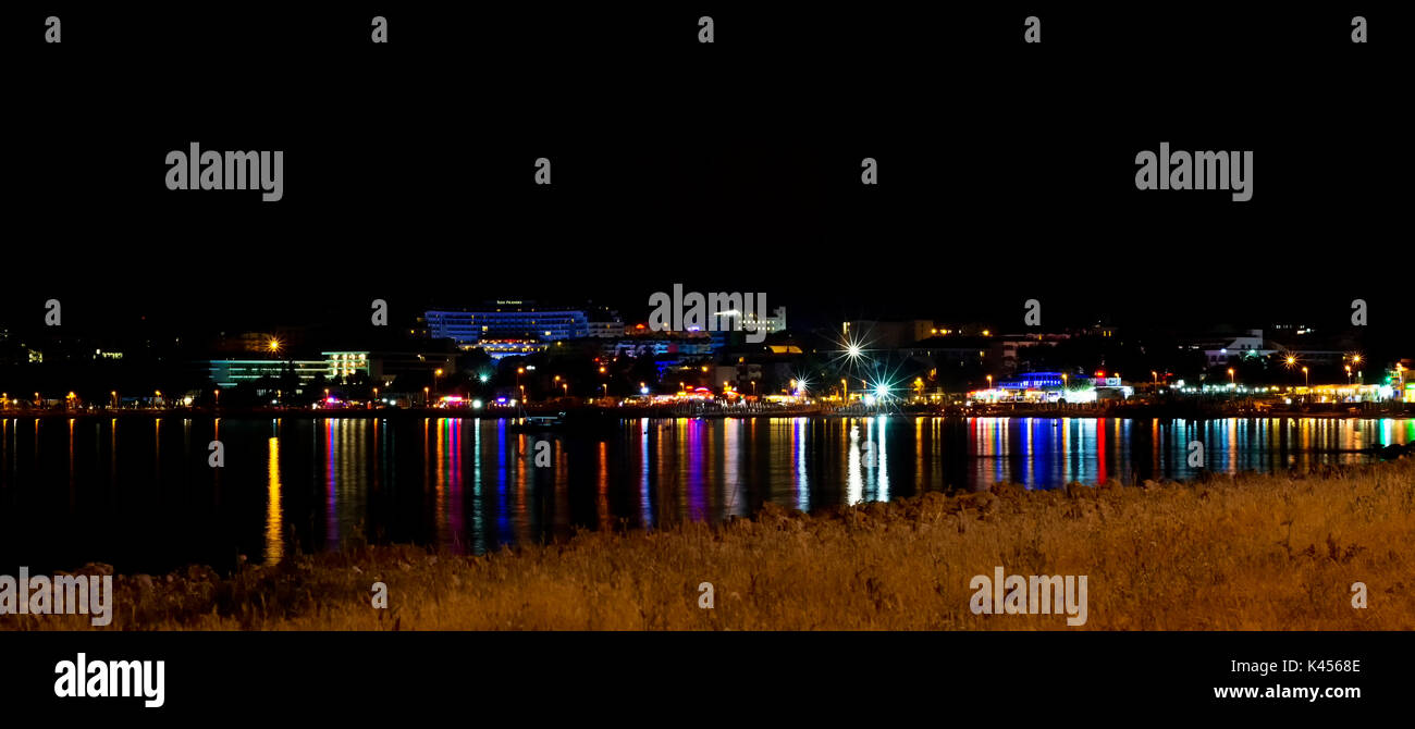 Waterfront at night in Side, Turkey. Colourful lights reflect in the ...