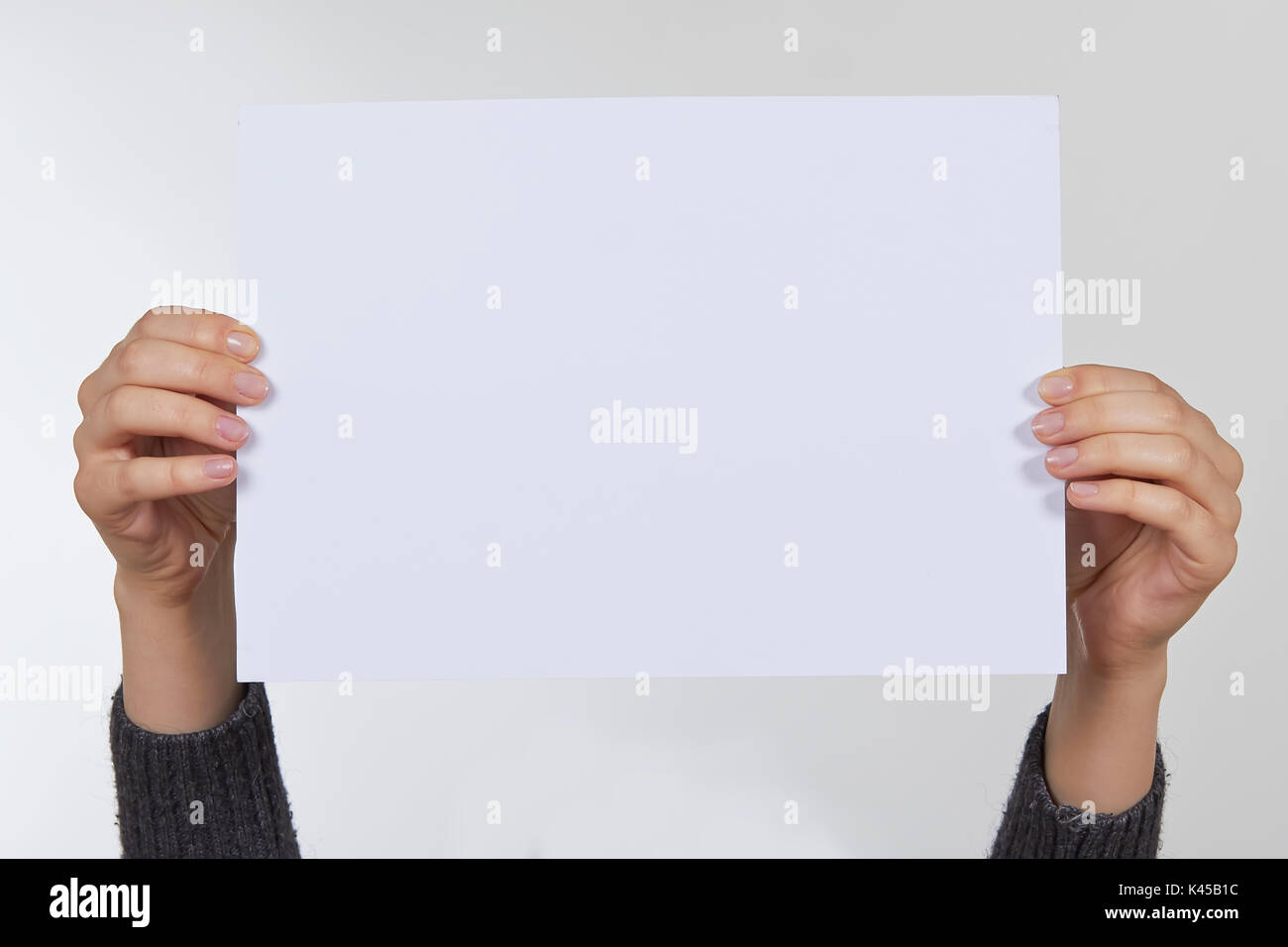 Hand holding paper isolated on white Stock Photo - Alamy