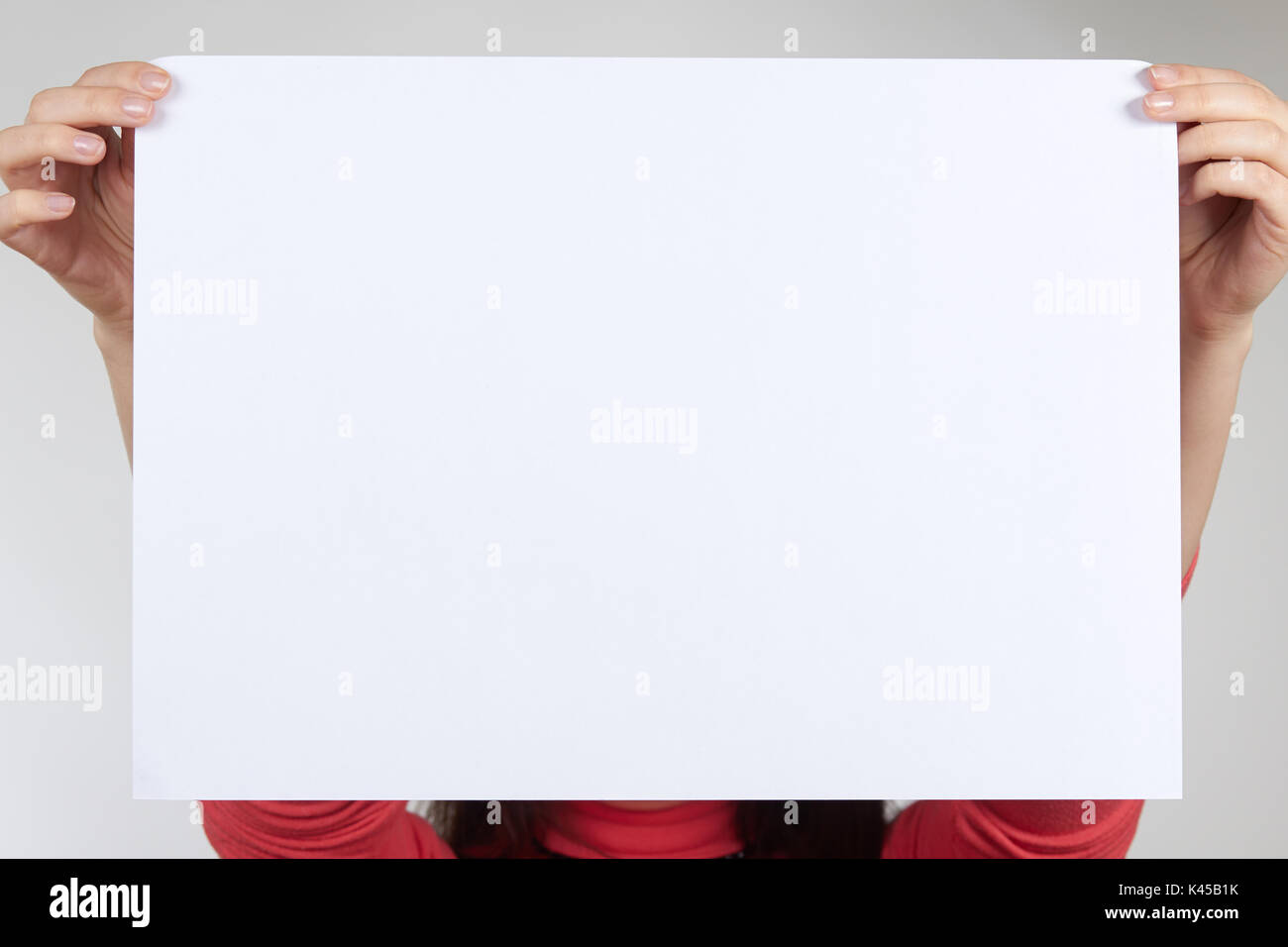 Hand holding paper isolated on white Stock Photo - Alamy