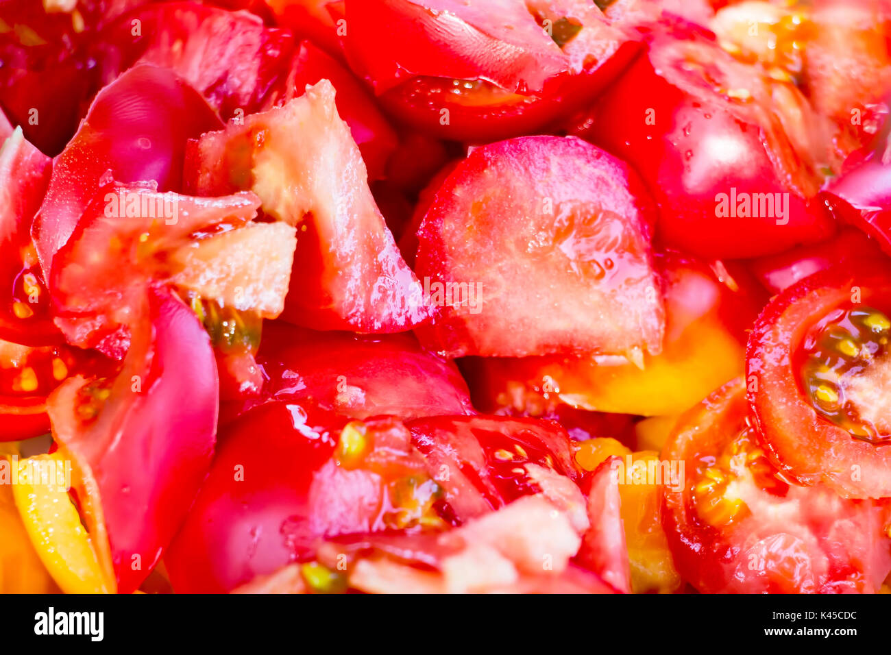 Tomato cut into slices for salad Stock Photo - Alamy