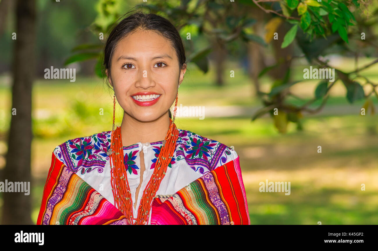 Young indigenous woman wearing a typical andean clothes, covering her ...
