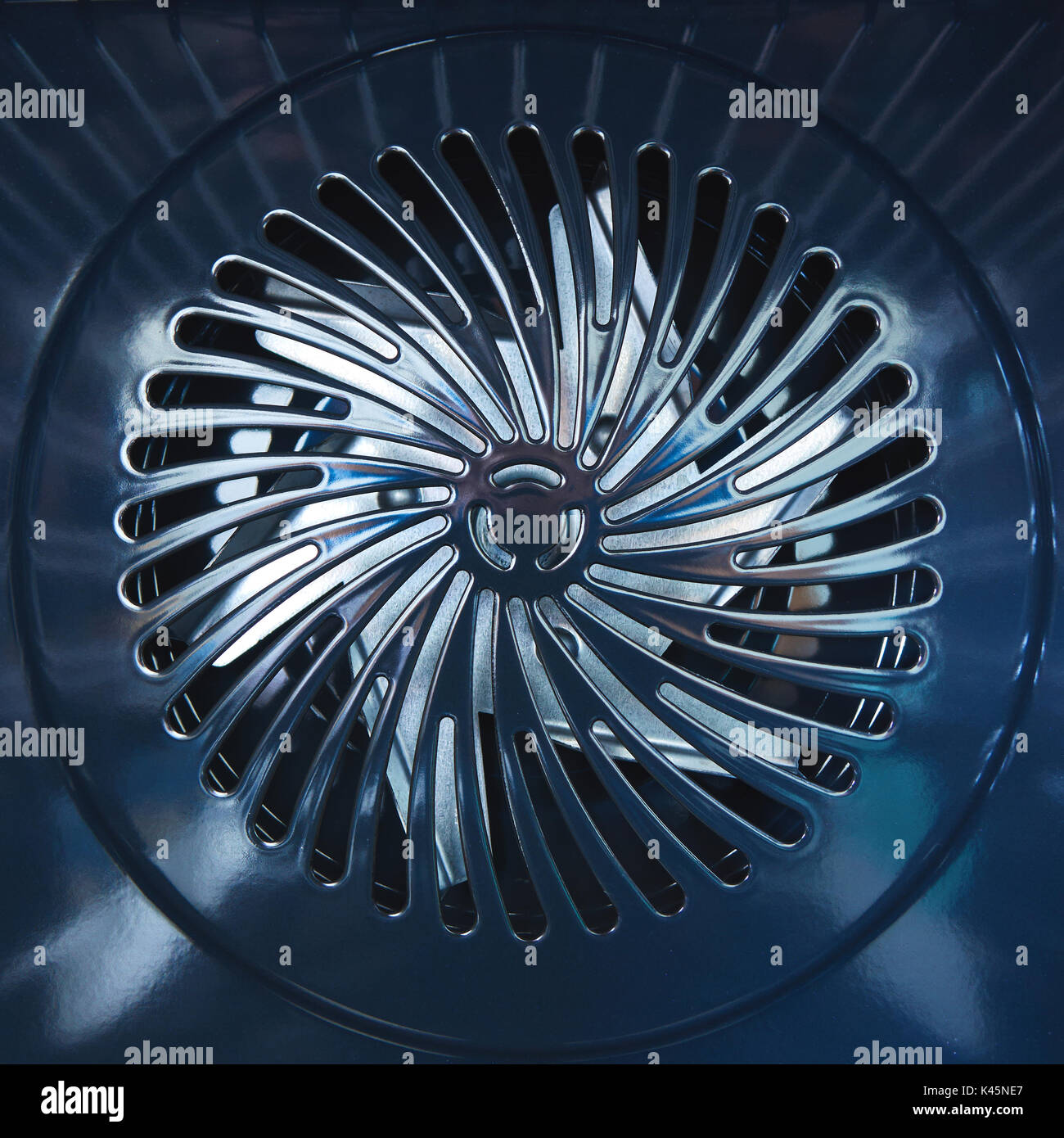 Close-up of a metal fan. Inside An empty metal modern stove with ...