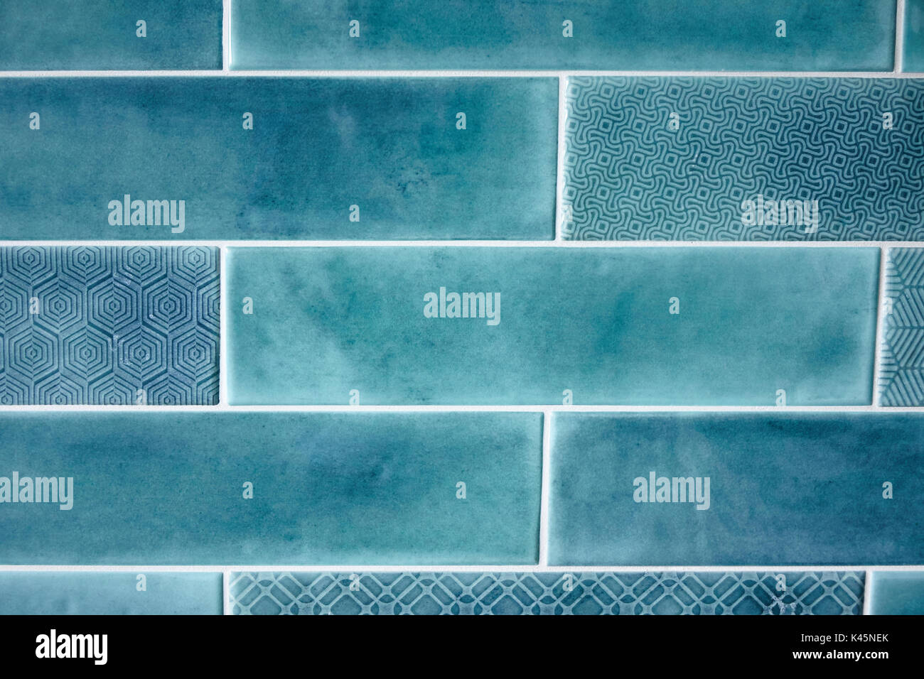 Background and texture of blue rectangular tiles with a pattern on some ...