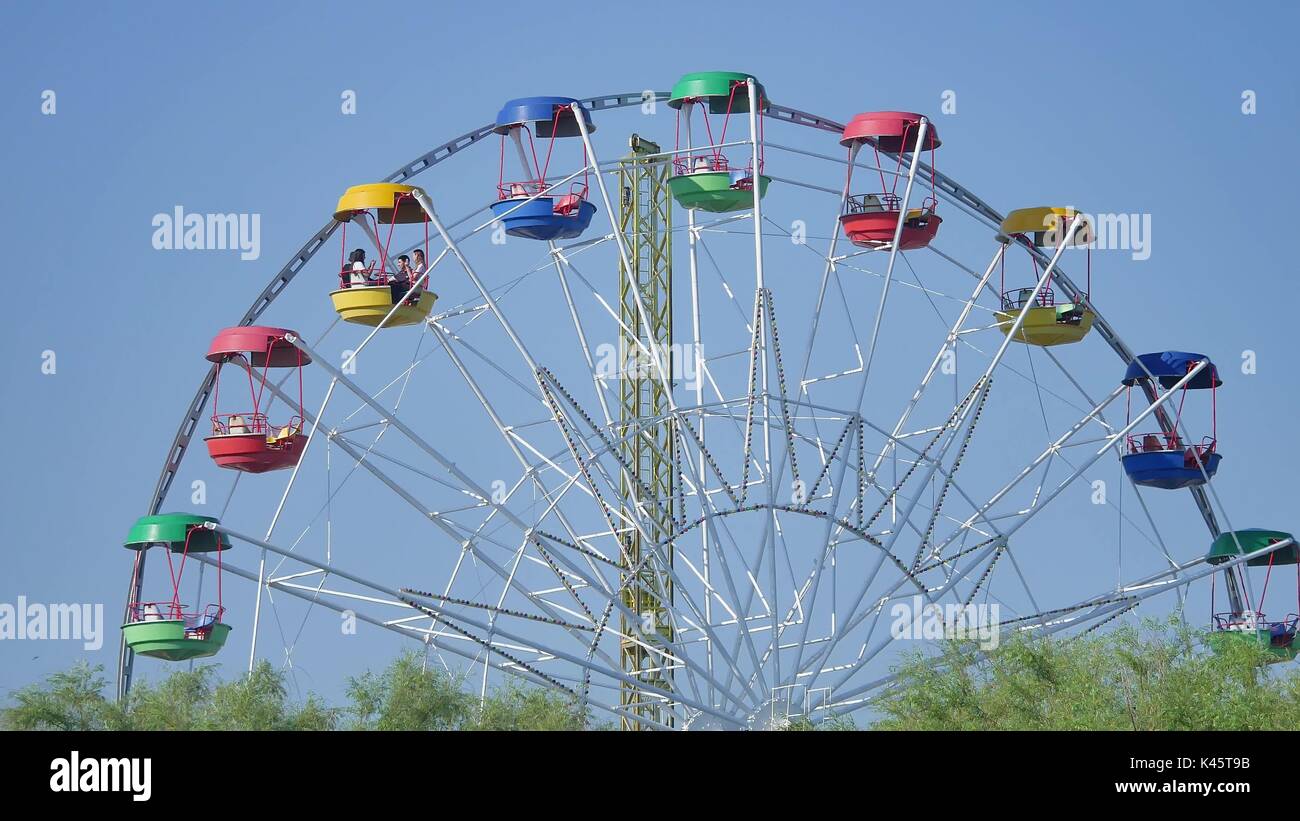 Amusement park. Ferris Wheel Over Blue Sky. Amusement park Stock Photo ...