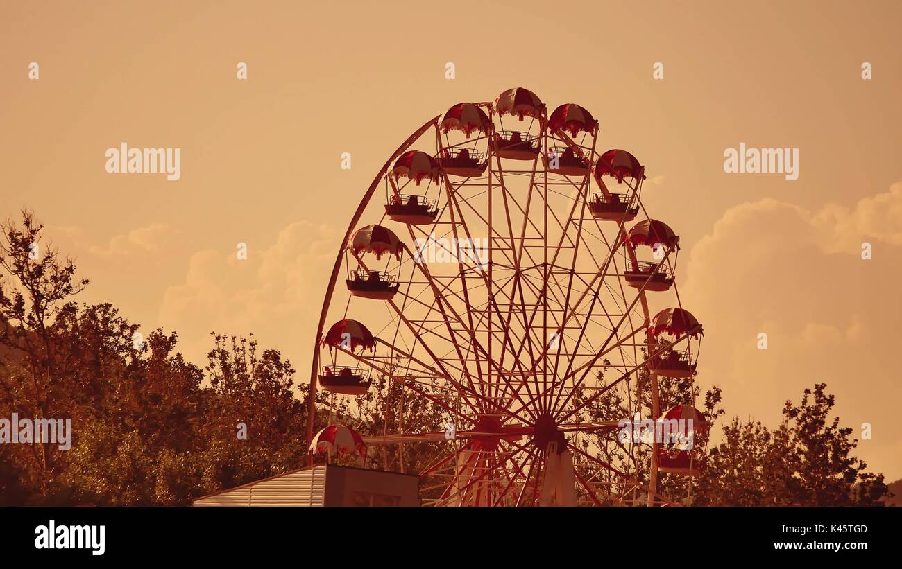 Amusement park sunset. Ferris Wheel Over Blue Sky. Amusement park Stock ...