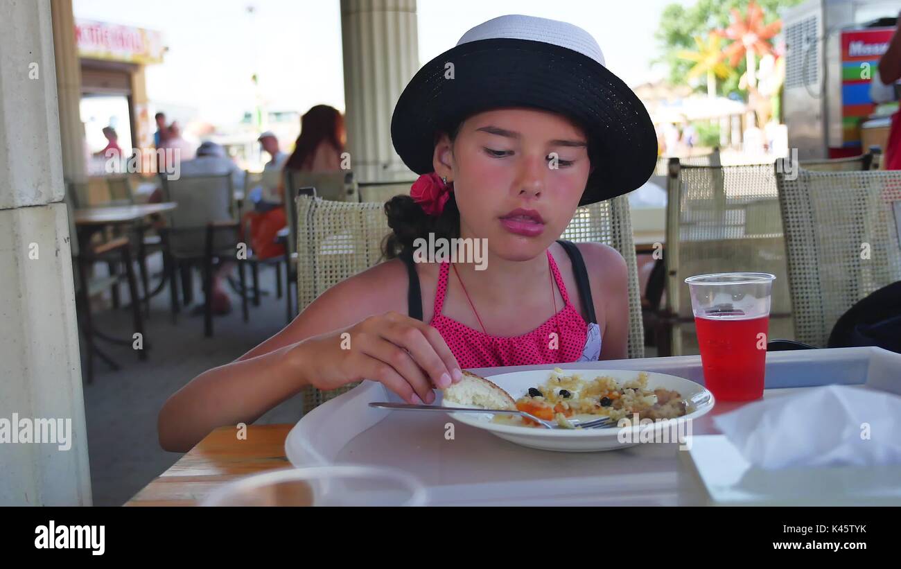 Girl teen eats at a cafe. Girl teenager eating lunch delicious outdoor ...