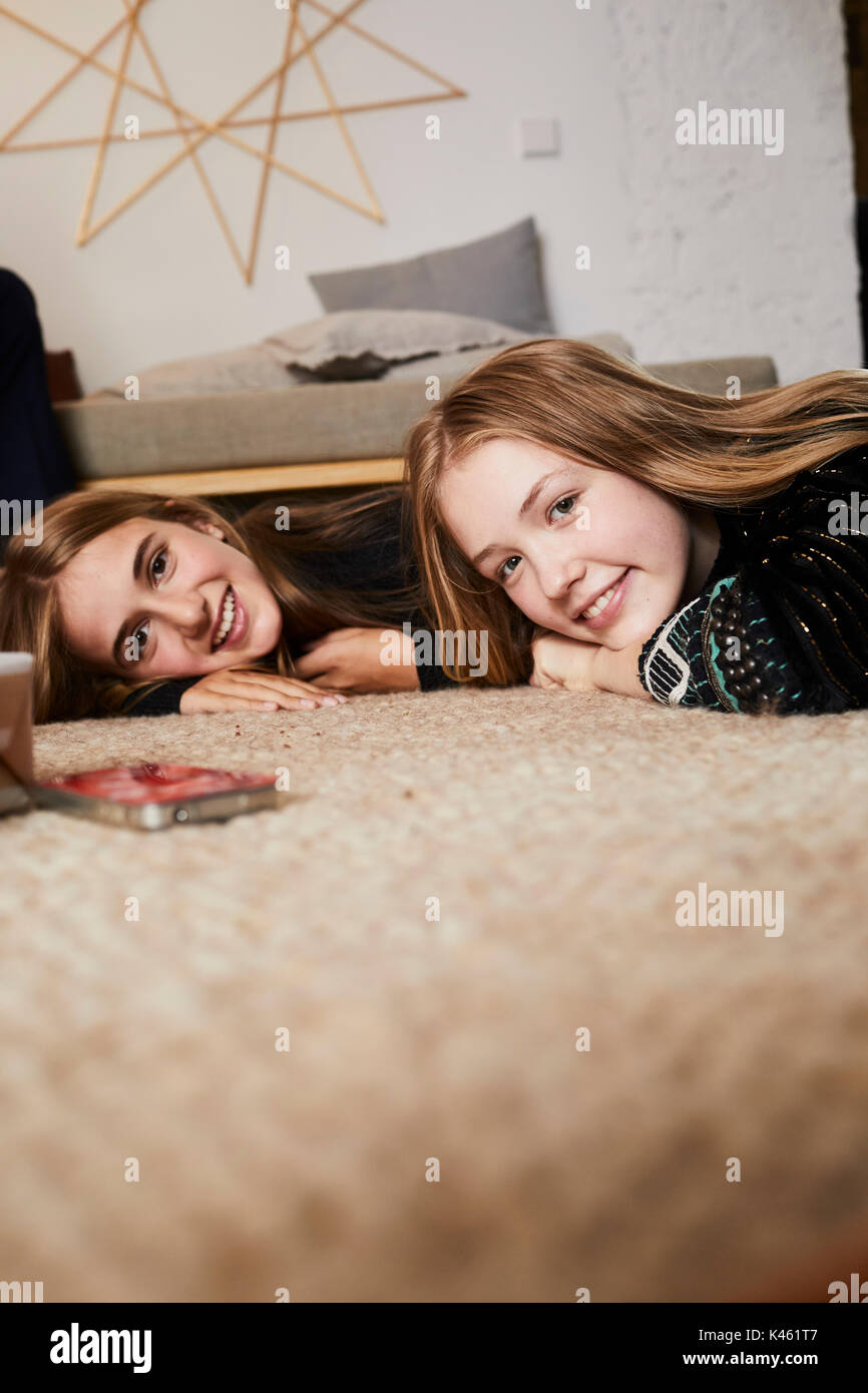 Two girls lie on the carpet hi-res stock photography and images - Alamy