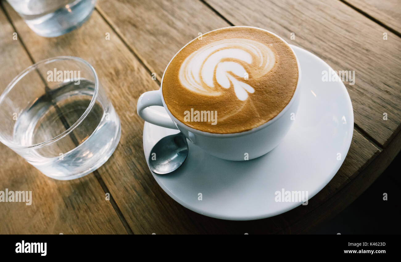Closeup of barista made coffee with froth art Stock Photo - Alamy