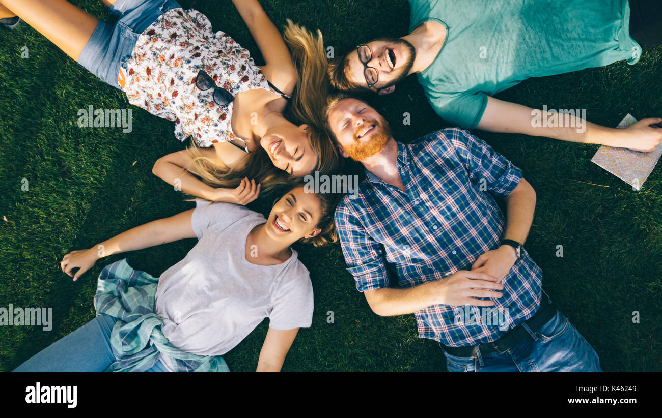 Happy joyful students lying in grass Stock Photo - Alamy
