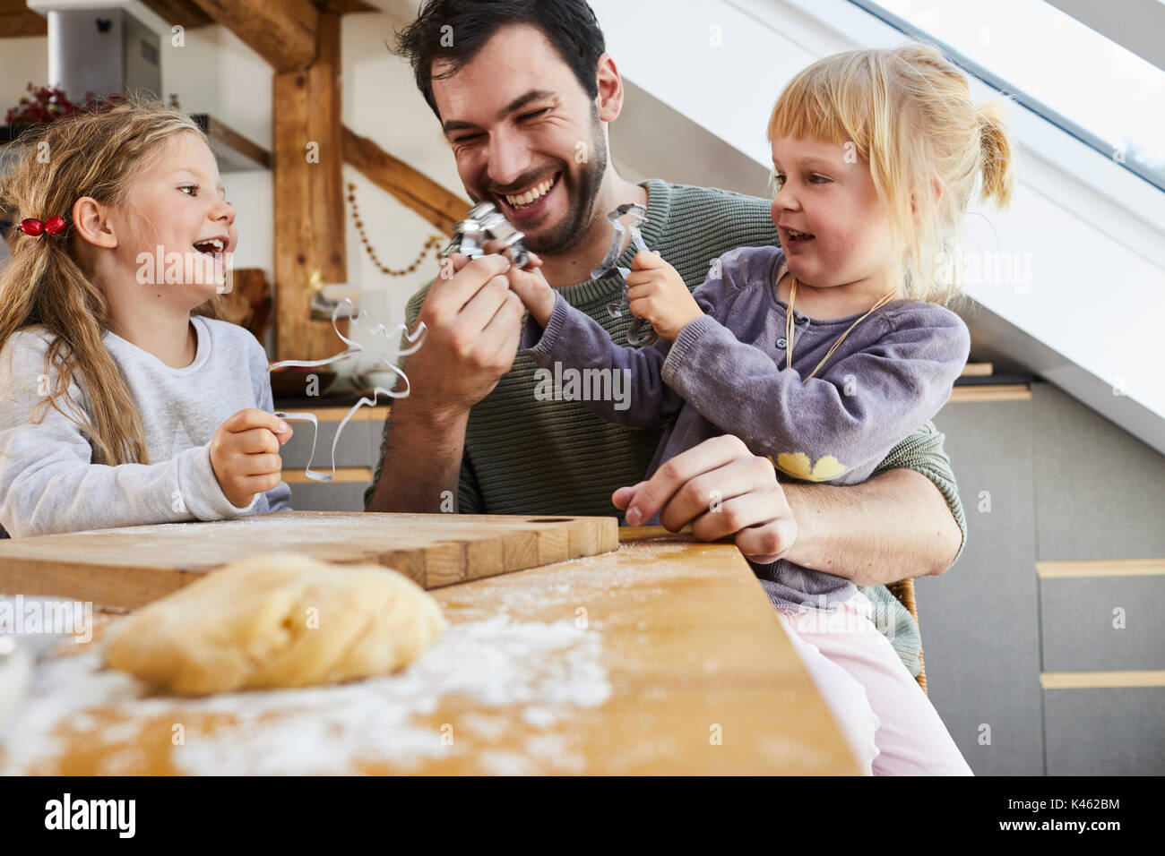 Family baking christmas cookies, father and daughters having fun Stock ...