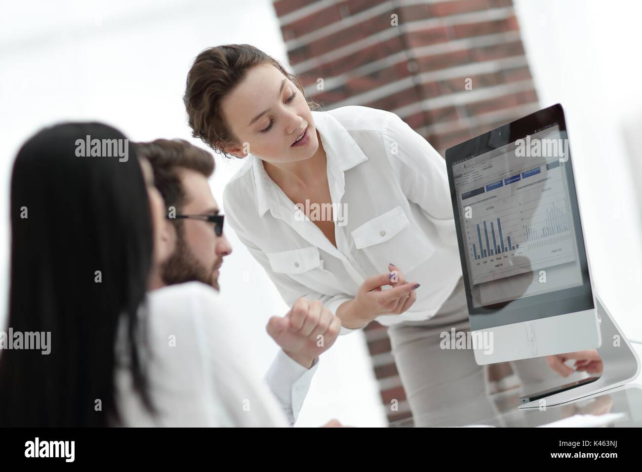specialists of the company discussing financial schedules at the desk ...