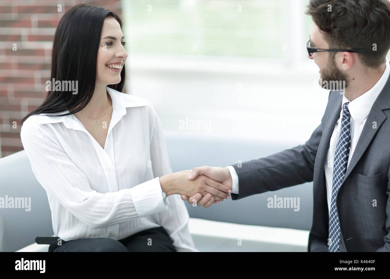 handshake of manager and client sitting in the office lobby Stock Photo ...