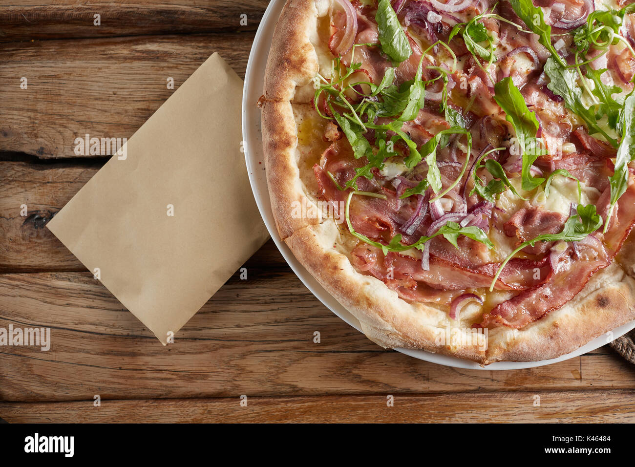 Close up of ingredients of rounded tasty italian pizza with broom ...