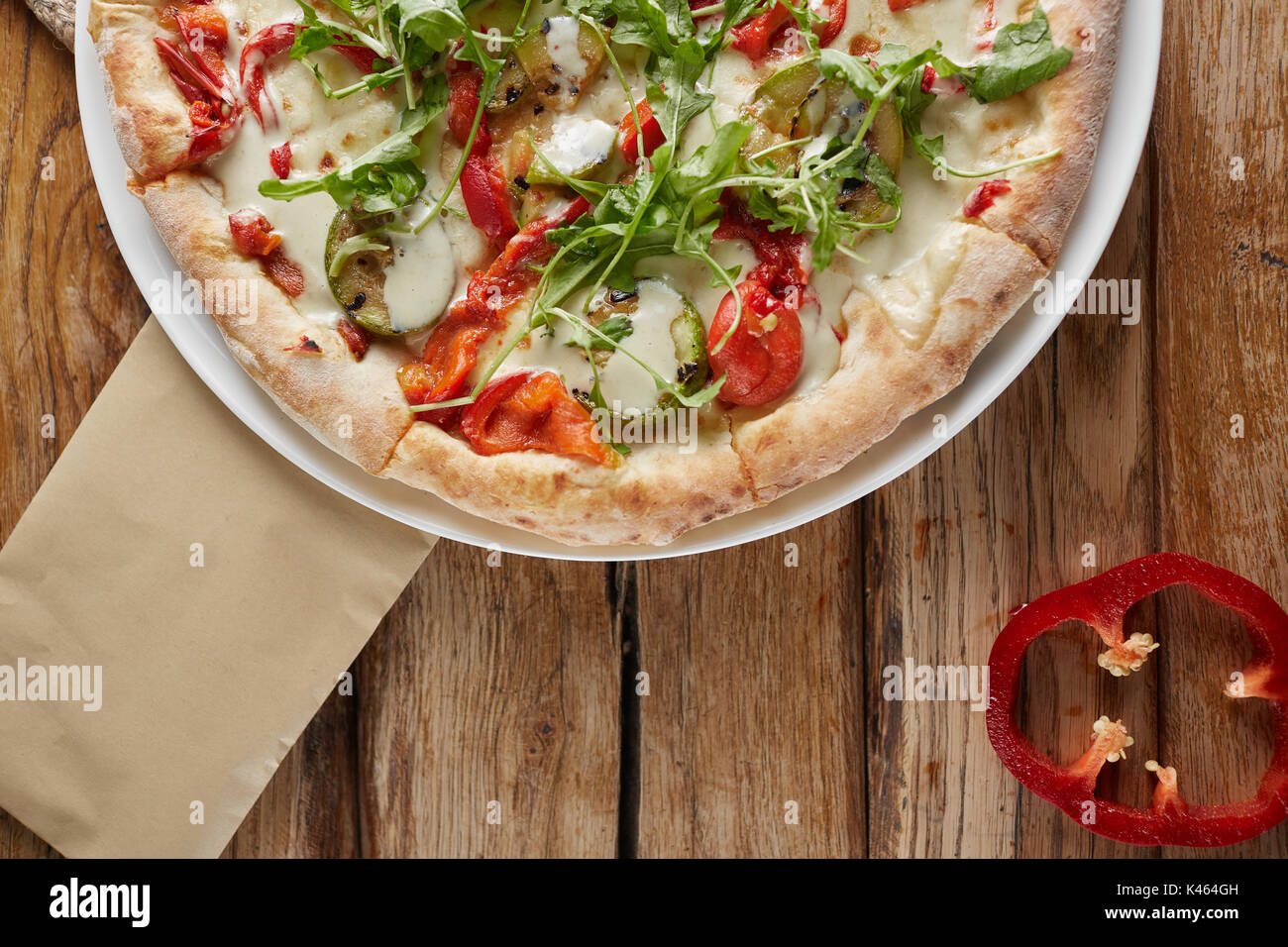 Crop of tasty vegetarian pizza with vegetables, tomato souse, paper ...