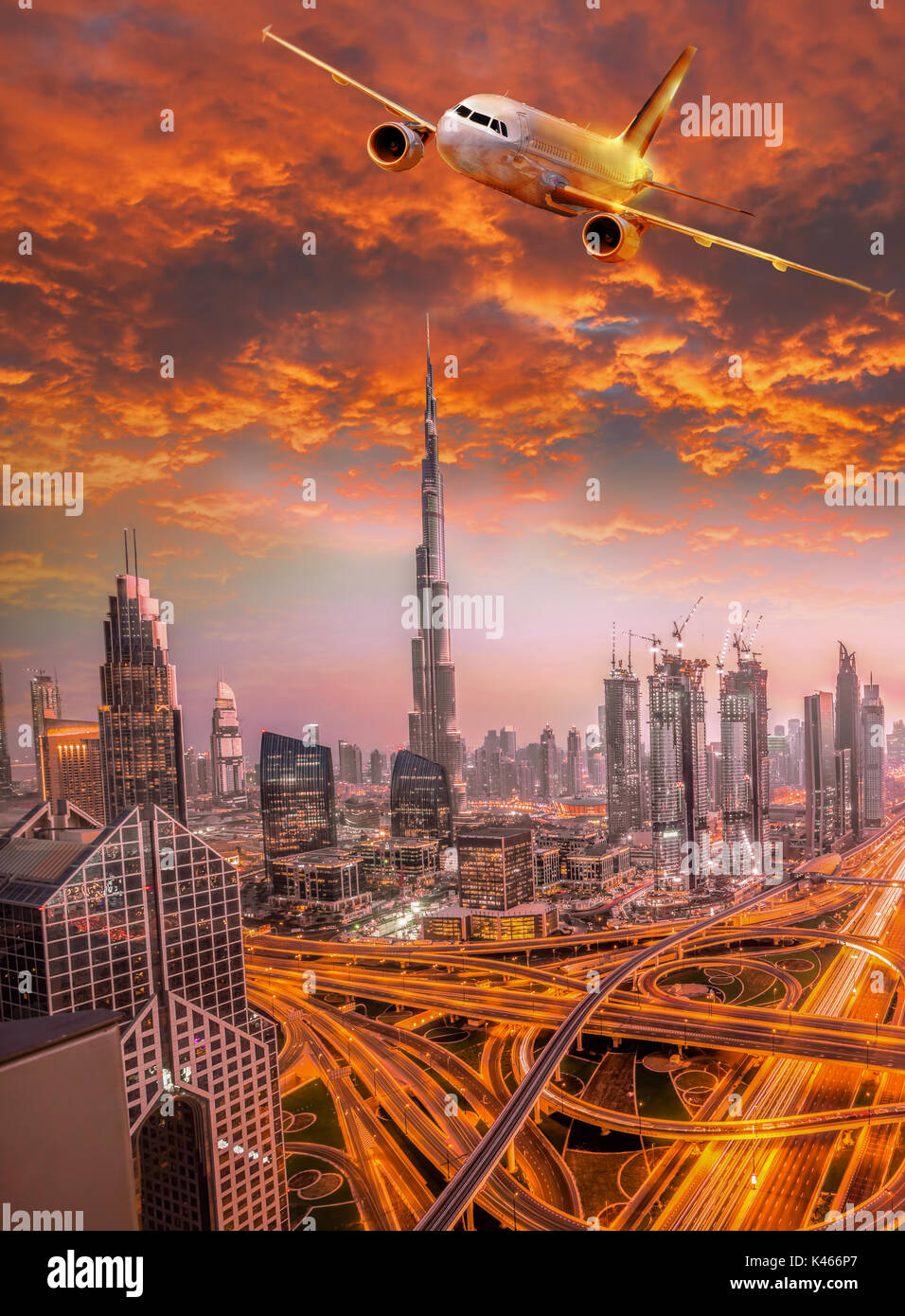 Airplane is flying over Dubai against colorful sunset in United Arab ...
