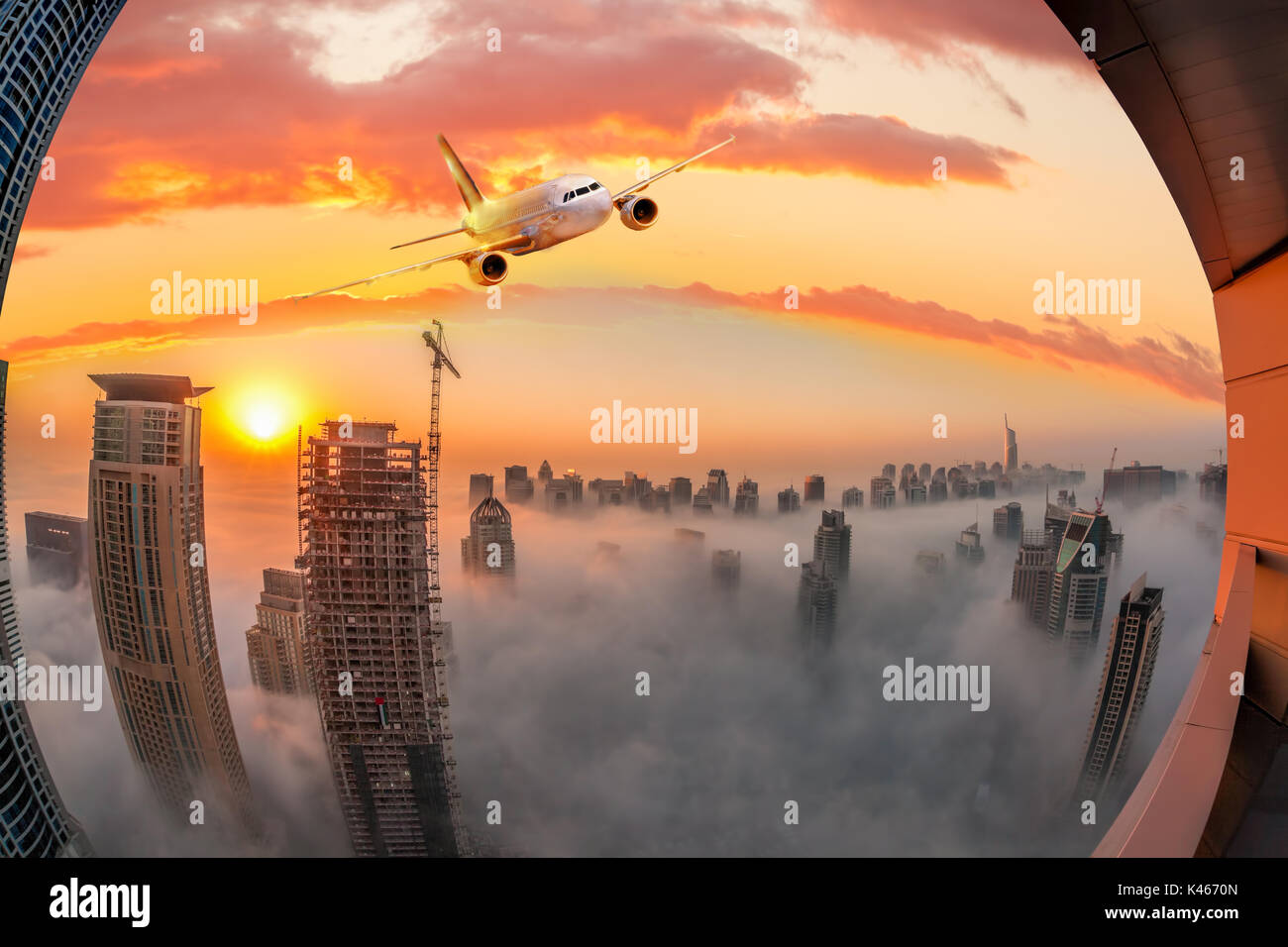 Plane is flying over Dubai against colorful sunset in United Arab ...