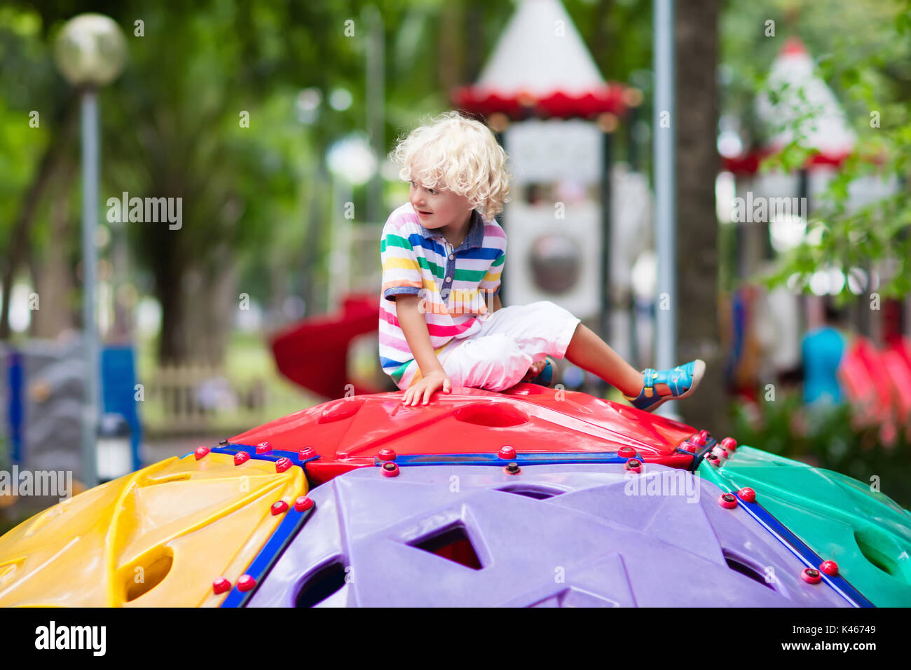 Kids on playground. Children play in summer park. Child on slide and ...