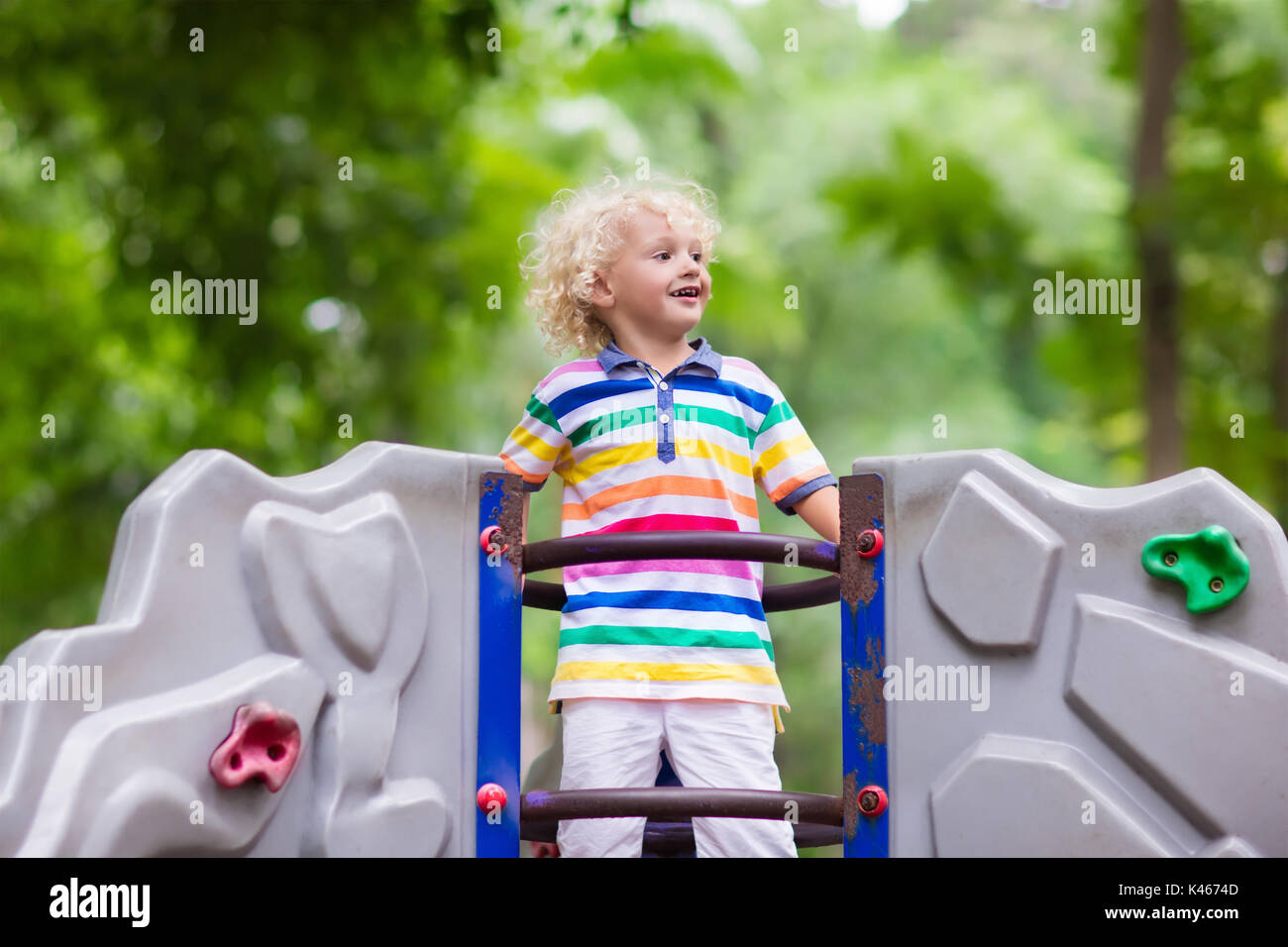 Kids on playground. Children play in summer park. Child on slide and ...