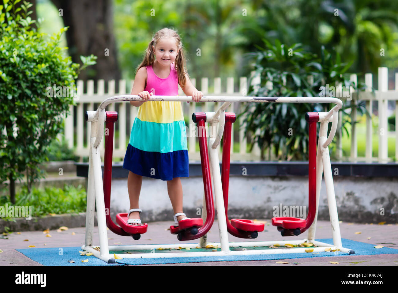 Kids on playground. Children play in summer park. Child on slide and ...